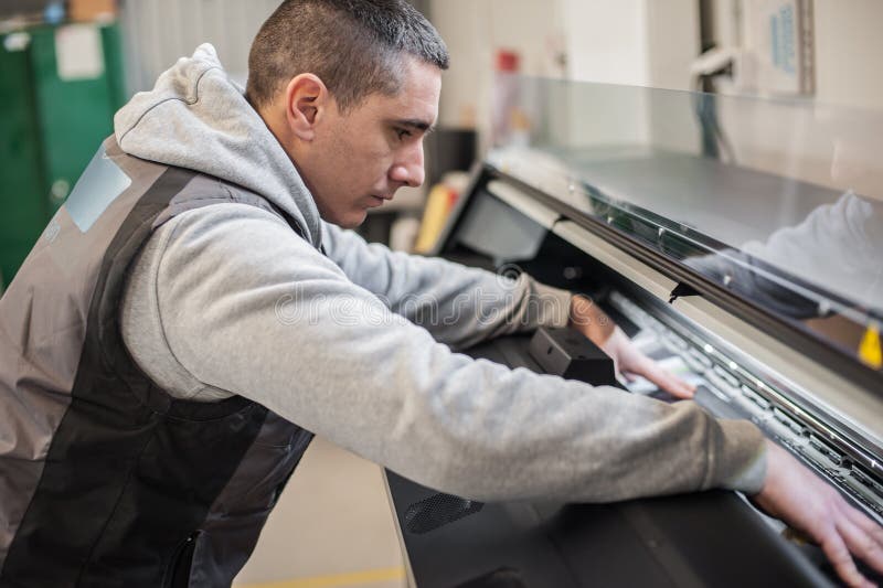 Technician Operator Changes Paper Roll on Large Printer Plotter Machine ...