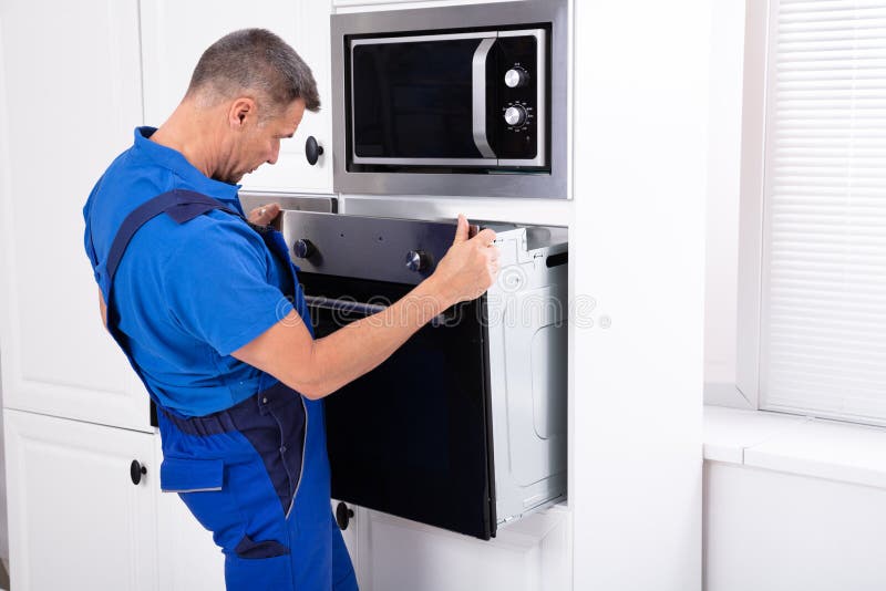 Technician in Overall Installing Oven Stock Photo - Image of closeup ...