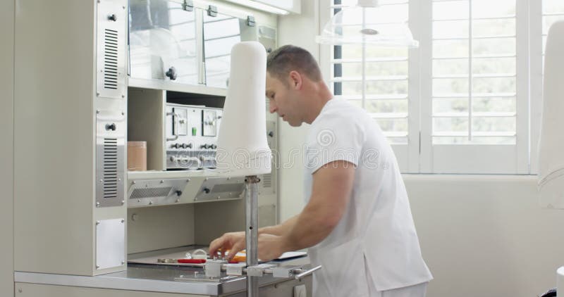 Technician in Prosthetic Lab Working on Artificial Limb, Adjusting ...