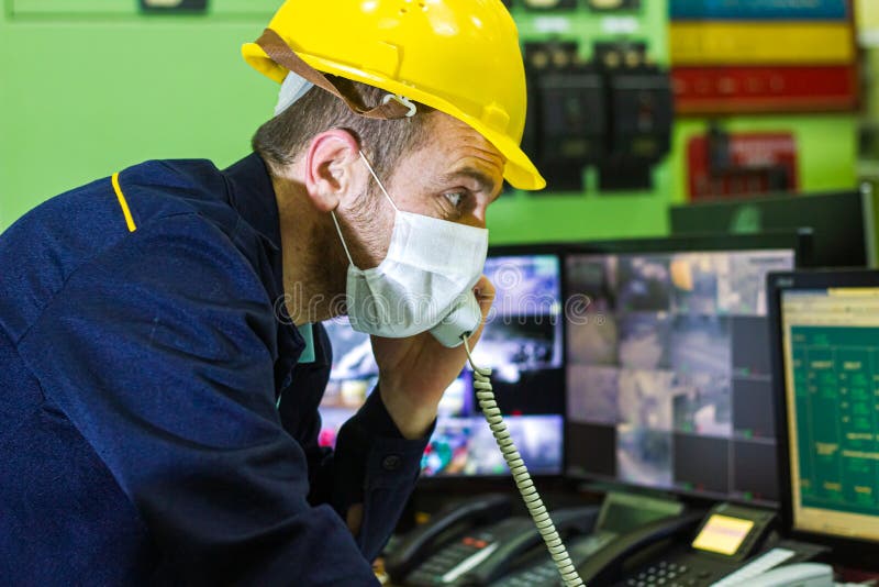 Technician with Protective Mask Working on Computer and Doing Telephone ...