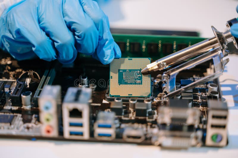 The Technician is Putting the CPU on the Socket of the Computer ...