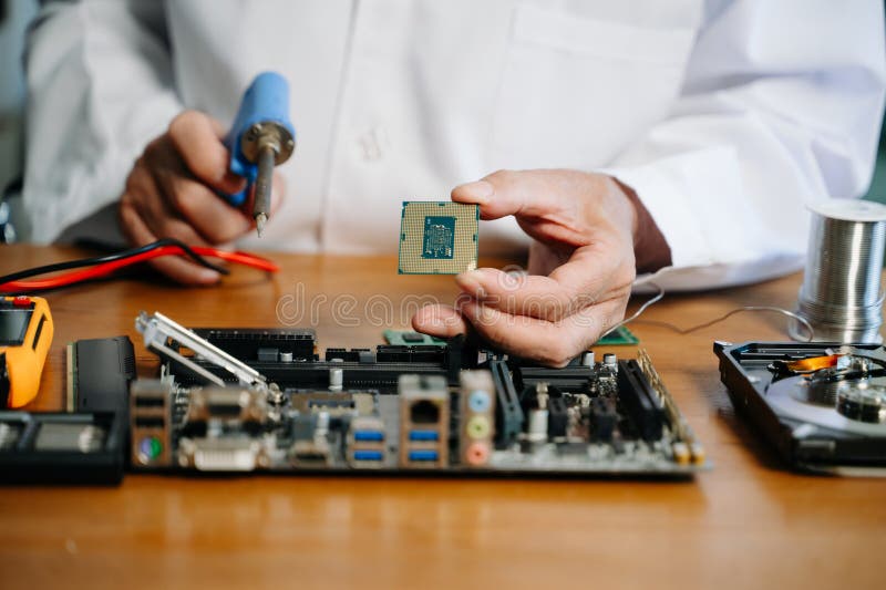 The Technician is Putting the CPU on the Socket of the Computer ...