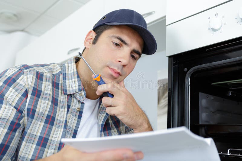 Technician reading manual stock image. Image of maintenance - 233685741