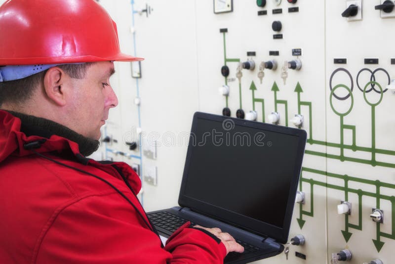 Technician in Red with Laptop Reading Instruments in Power Plant Stock ...