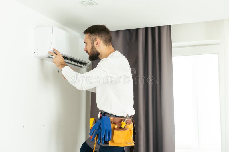 Technician Repairing Air Conditioner on the Wall Stock Photo - Image of ...