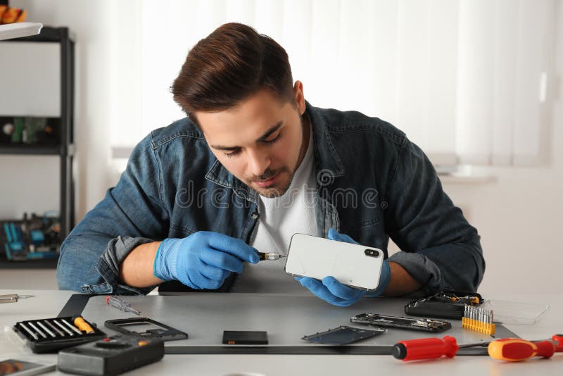 Technician Repairing Broken Smartphone at Table Stock Image - Image of ...
