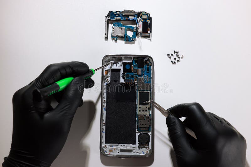 Technician Repairing Broken Smartphone at White Table, Top View Stock ...