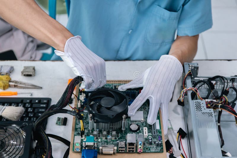 A Technician is Repairing a Computer by Cleaning the Cooling Fan ...