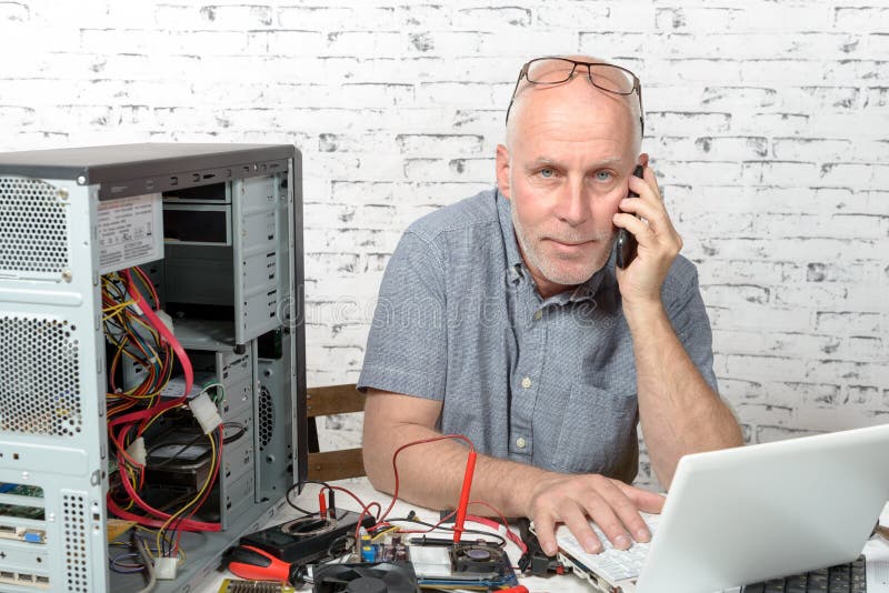 A Technician Repairing a Computer Stock Image - Image of geek, looking ...