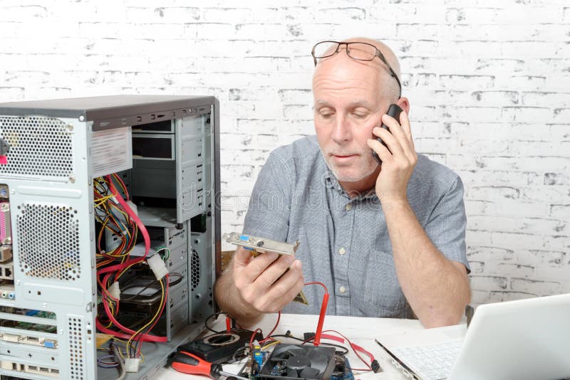 A Technician Repairing a Computer and Phone Stock Image - Image of ...