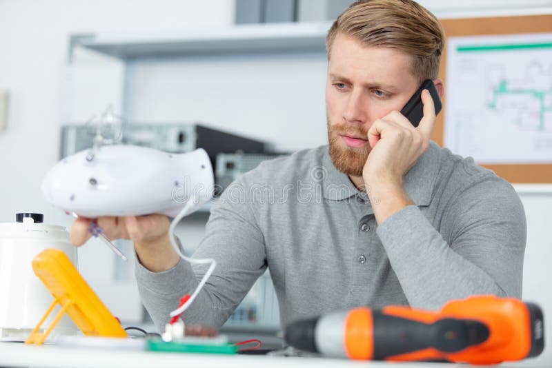 Technician Repairing Electronic Machine Stock Photo - Image of ...