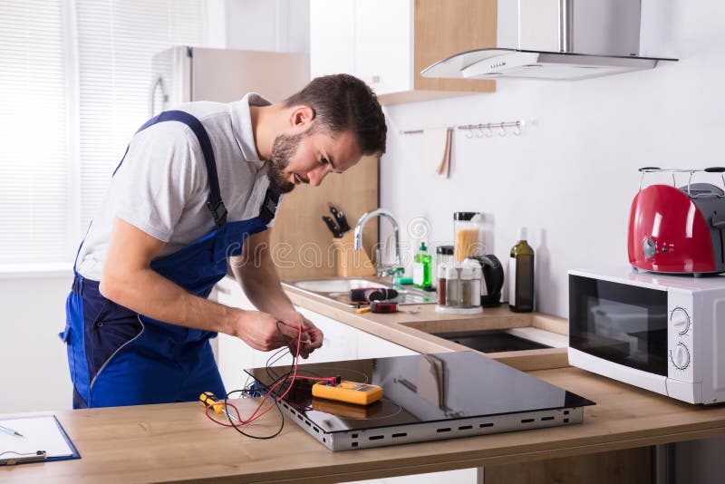 Technician Repairing Induction Stove in Kitchen Stock Photo - Image of ...