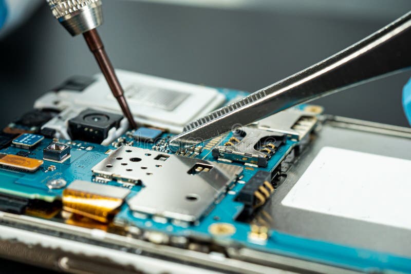 Technician Repairing Inside of Hard Disk by Soldering Iron. Integrated ...