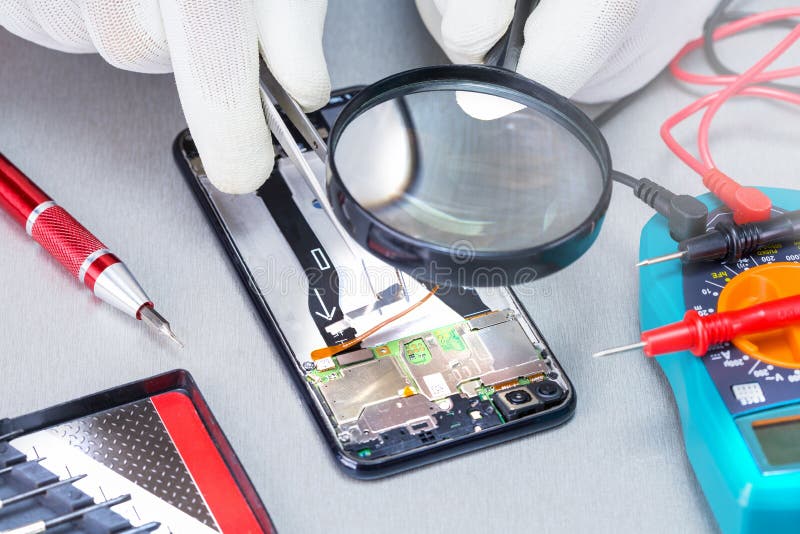 Technician Repairing Inside of Mobile Phone on Desk. Stock Photo ...