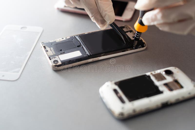 Technician Repairing Inside of Mobile Phone by Soldering Iron. the ... Technician Repairing Inside of Mobile Phone by Soldering Iron. the ...