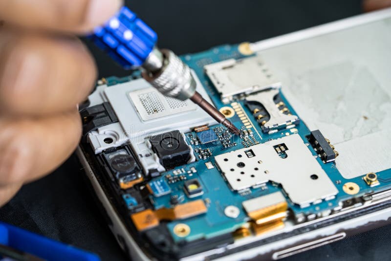 Technician Repairing Inside of Mobile Phone by Soldering Iron ...