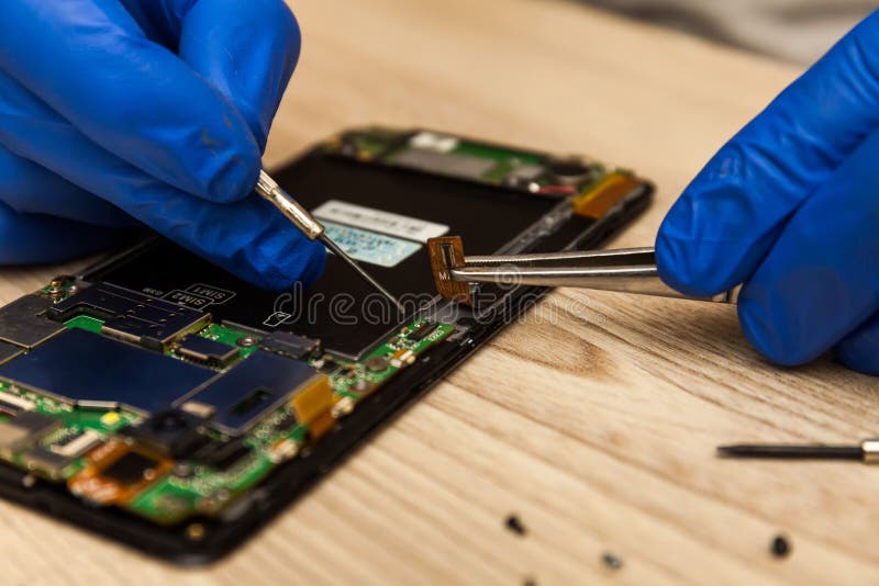 Repairing the Mobile Phone. the Man`s Hands Take Out the Circuit Board ...