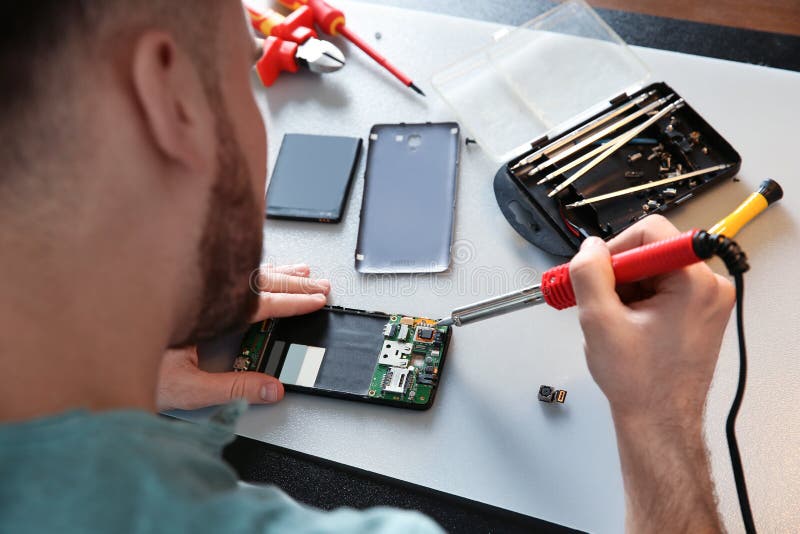 Technician Repairing Mobile Phone at Table Stock Photo - Image of ...