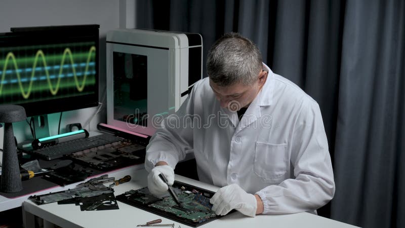 Technician Repairs Circuit Board in Modern Workspace with Electronic ...