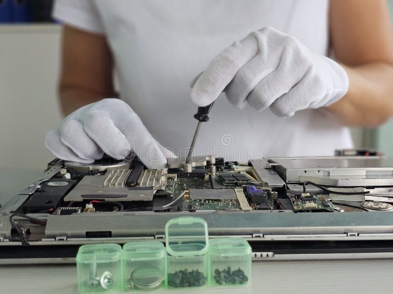 Technician Repairs Laptop Motherboard Using Precision Tools in a Well ...