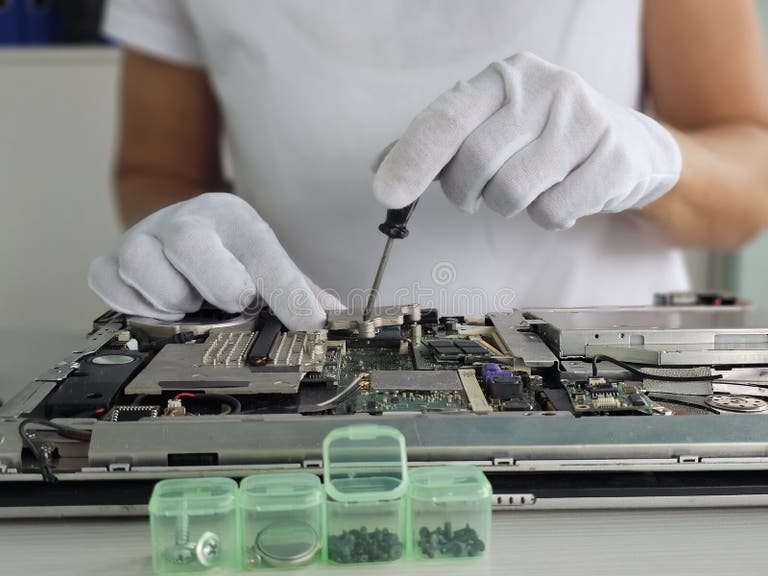 Technician Repairs Laptop Motherboard Using Precision Tools in a Well ...