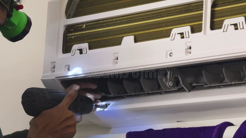 A Technician Repairs a Wall Mounted Air Conditioner and Fixing HVAC ...