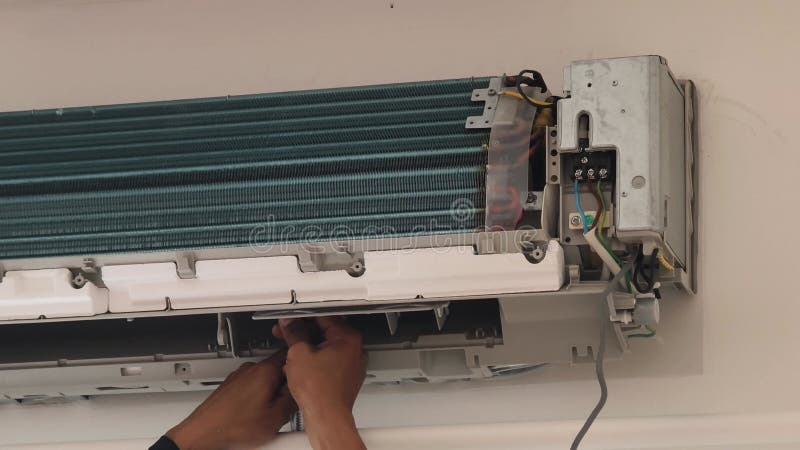 A Technician Repairs a Wall Mounted Air Conditioner and Fixing HVAC ...