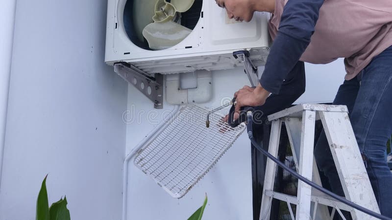 A Technician Rinsing a Wall Mounted Air Conditioner and Fixing HVAC ...