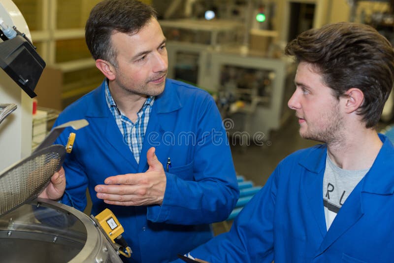 Technician Showing Machinery To Trainee Stock Image - Image of metallic ...