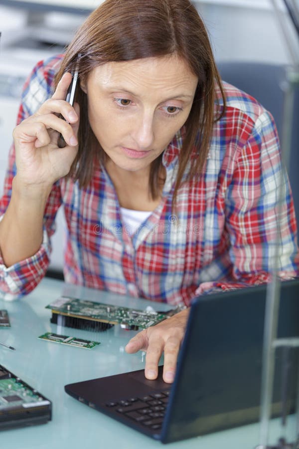 Technician Sitting in Office Running Diagnostics in Large Data Center ...