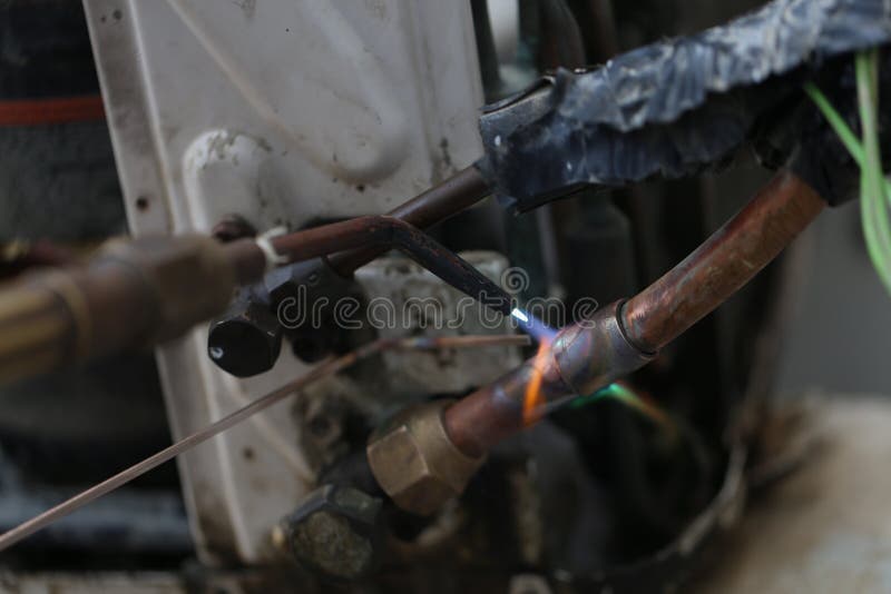 Technician are Soldering a Coil with Copper in Order To Fix Leakage of ...