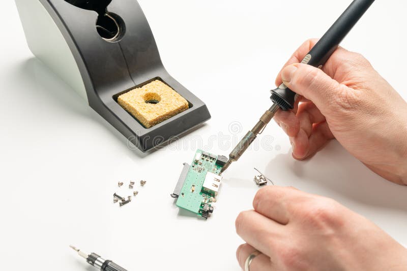 Technician Soldering an Electronic Component with a Soldering Iron ...