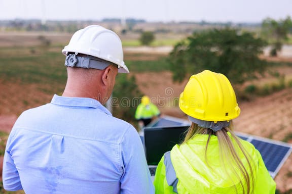 Technician Specialist and Engineers Examining Solar Panel Using Digital ...