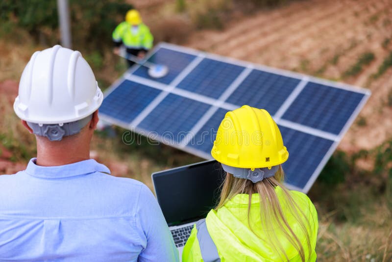 Technician Specialist and Engineers Examining Solar Panel Using Digital ...