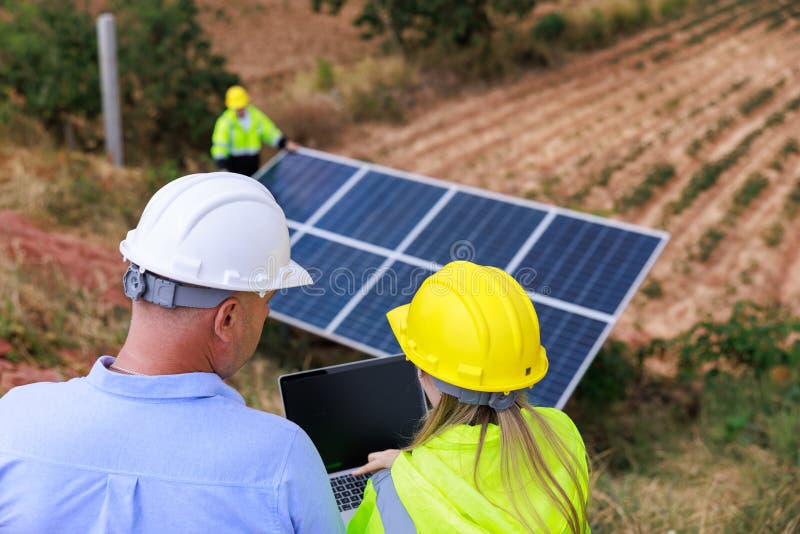 Technician Specialist and Engineers Examining Solar Panel Using Digital ...
