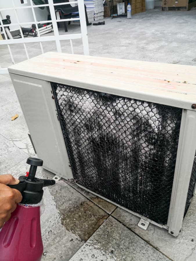 A Technician Spraying a Chemical Substance on Air Conditioner ...