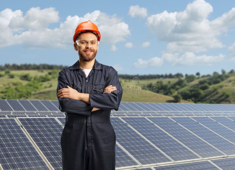 Technician Standing on a Field with Sustainable Solar Energy Panels ...