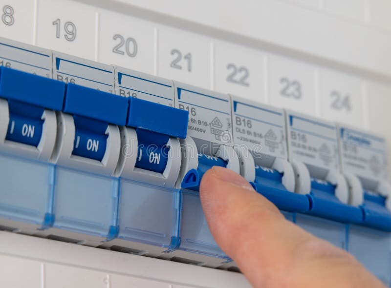 Technician Switches on Several Fuse in a Fuse Box of a Private House ...