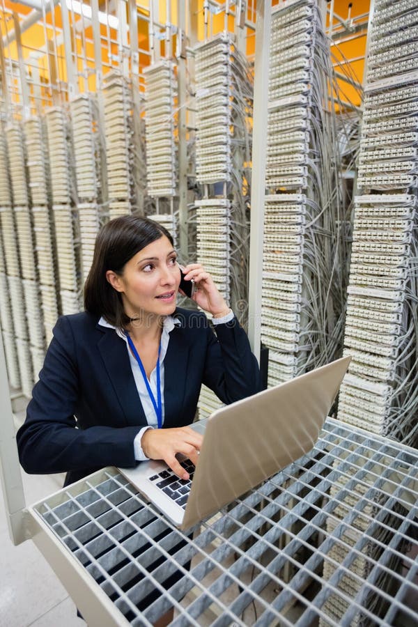 Technician Talking on Mobile Phone in Server Room Stock Image - Image ...