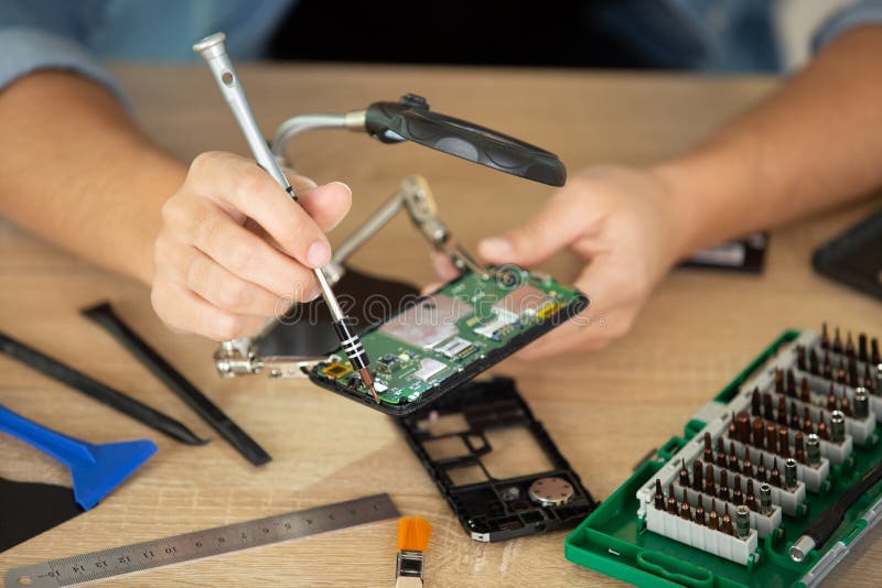 Technician Uses Precision Tool for Computer Repair Stock Photo - Image ...