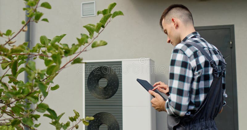 External Heat Pump Unit Against the Wall of the House. Modern ...