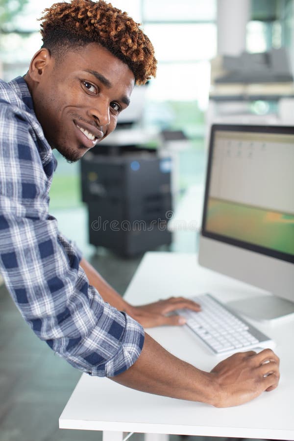 Technician Using Desktop Computer Smiles at Camera Stock Photo - Image ...