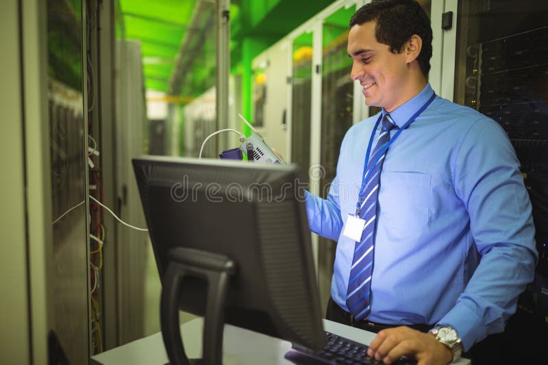 Technician Using Digital Cable Analyzer while Working on Personal ...