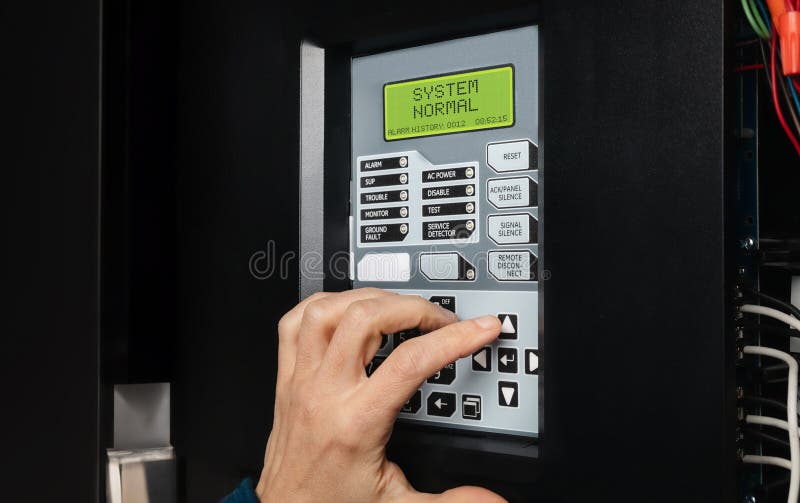Technician Using Fire Alarm Control Panel in Service Room. Stock Image ...