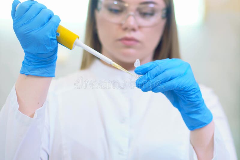 Technician Using Laboratory Pipette and Loading Samples To a Cen Stock ...