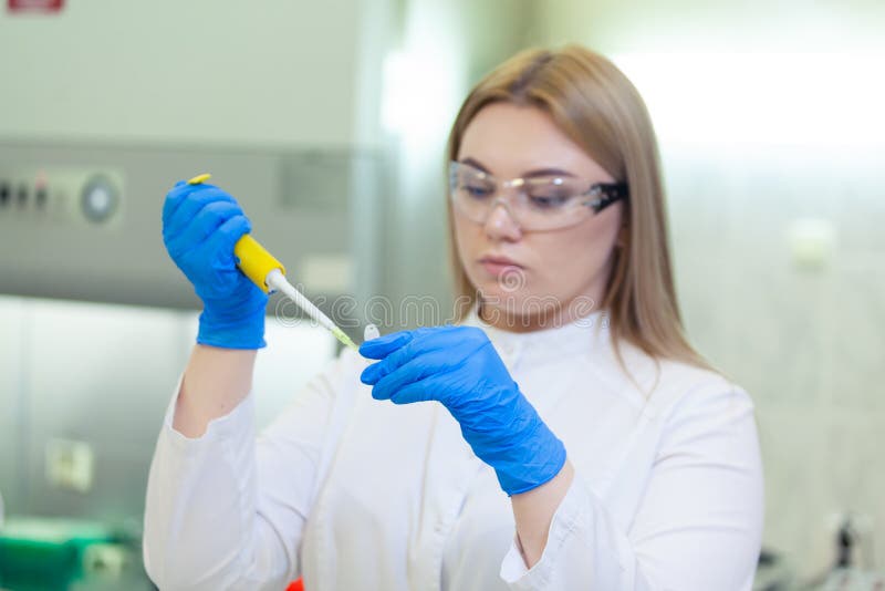 Technician Using Laboratory Pipette and Loading Samples To a Centrifuge ...