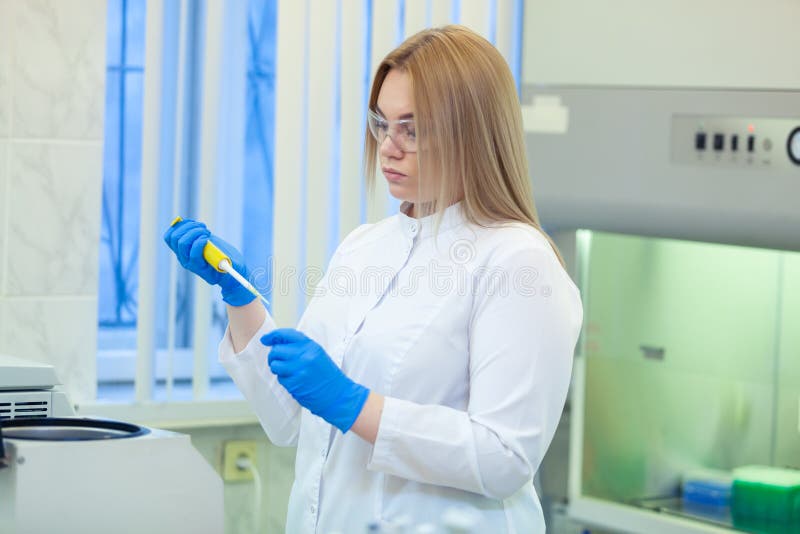 Technician Using Laboratory Pipette and Loading Samples To a Centrifuge ...