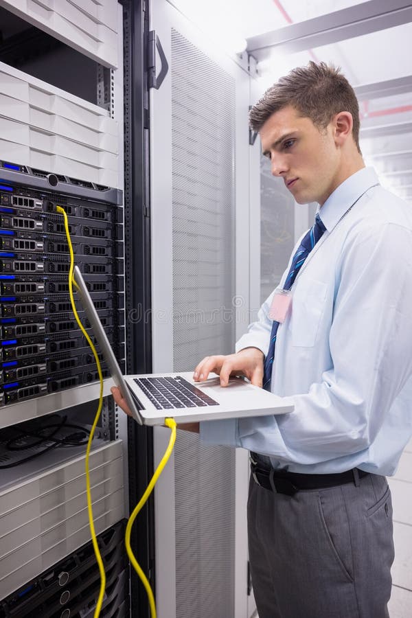 Technician Using Laptop while Analysing Server Stock Image - Image of ...