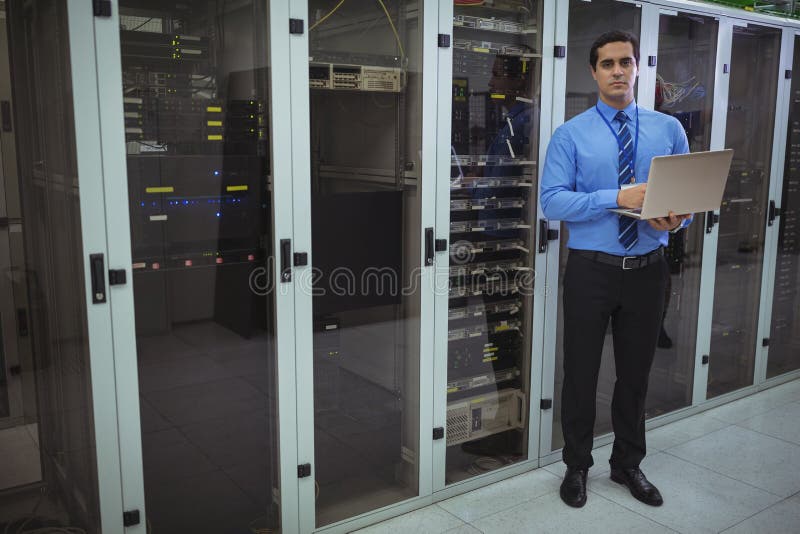 Technician Using Laptop while Analyzing Server Stock Photo - Image of ...