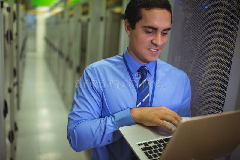 Technician Using Laptop while Analyzing Server Stock Photo - Image of ...